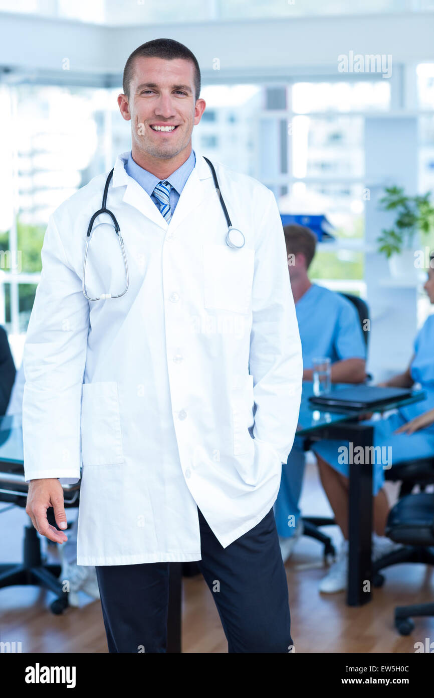 Handsome smiling doctor looking at camera Stock Photo - Alamy