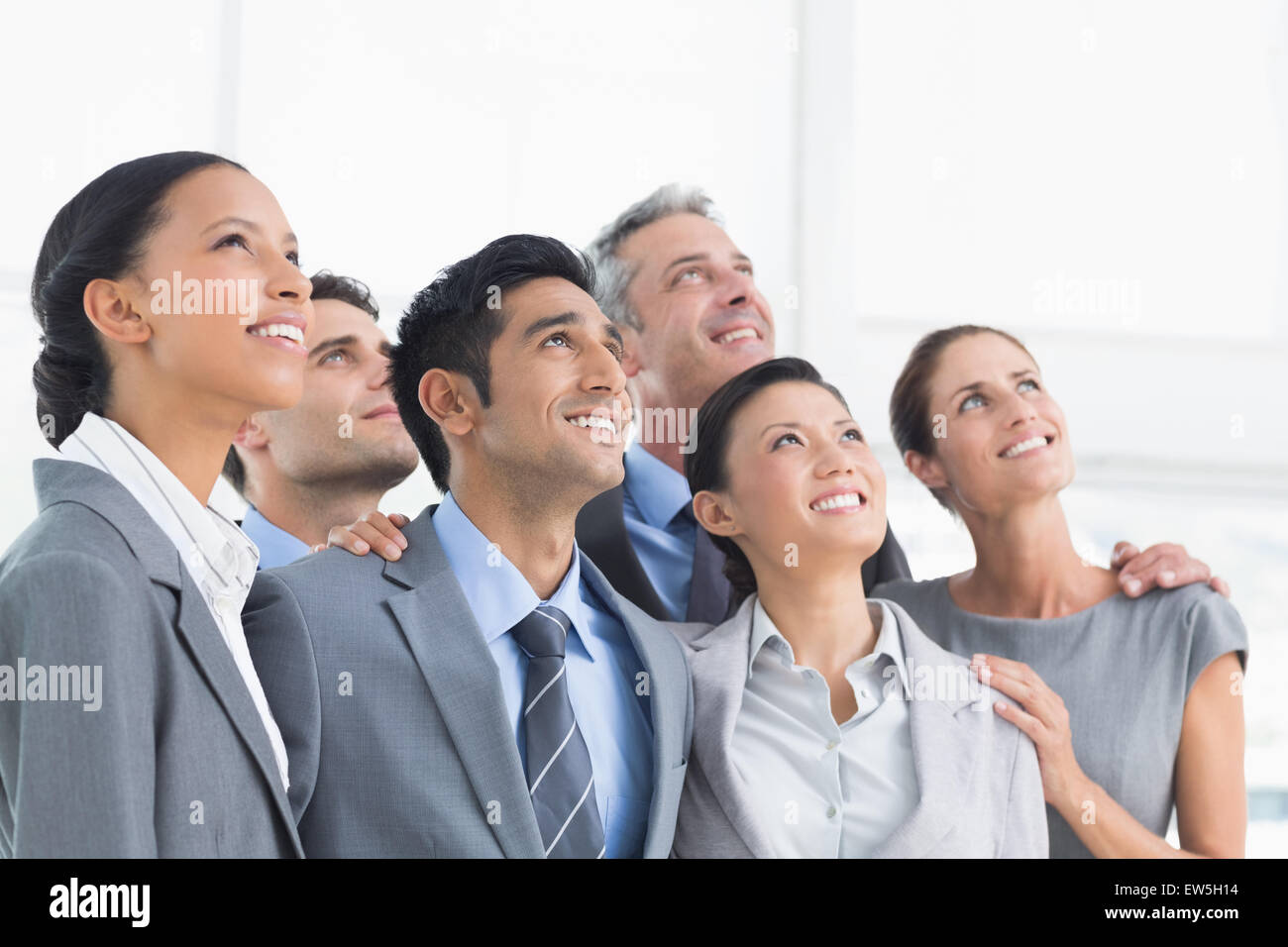 Business people looking up in office Stock Photo - Alamy
