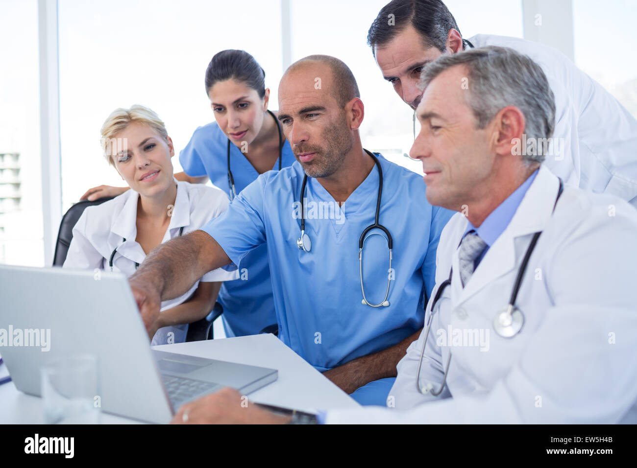 Doctor showing laptop pc to his colleagues Stock Photo - Alamy