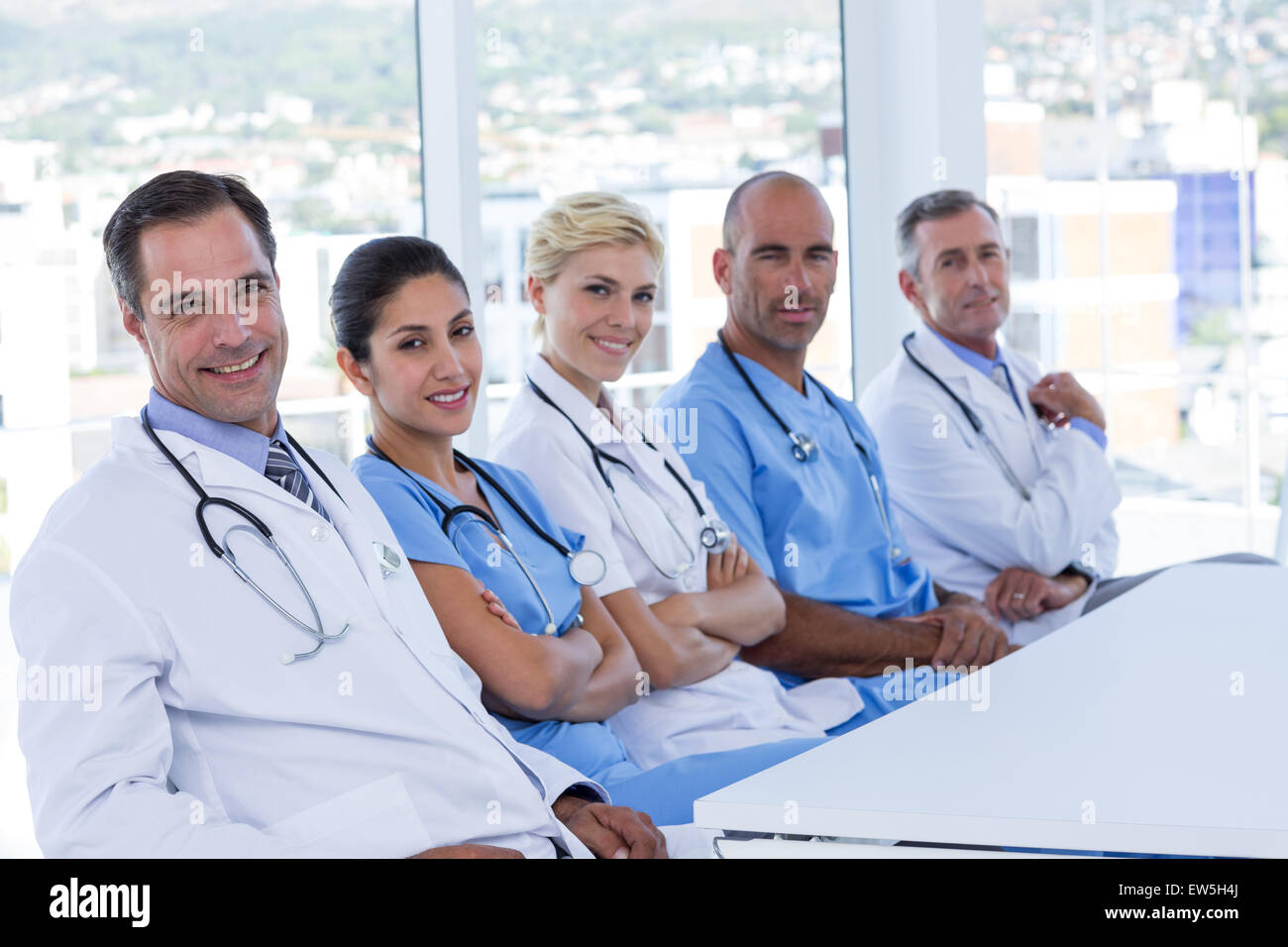 team of doctors looking at camera during meeting Stock Photo - Alamy
