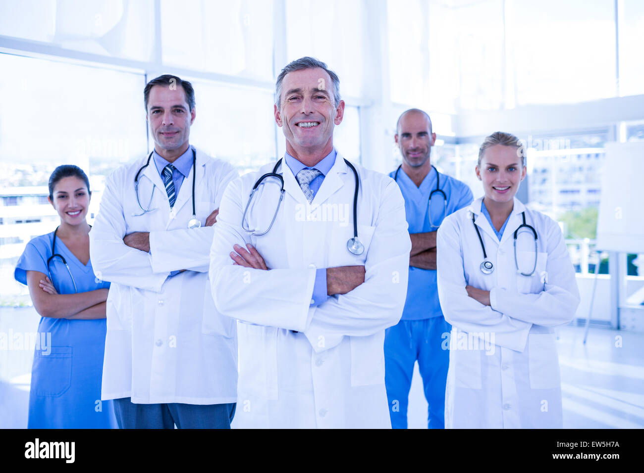 Team of smiling doctors looking at camera with arms crossed Stock Photo ...