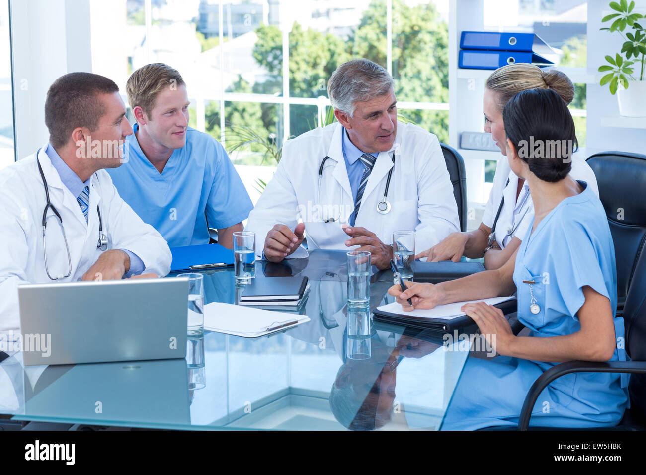 Team of doctors working together on patients file Stock Photo - Alamy