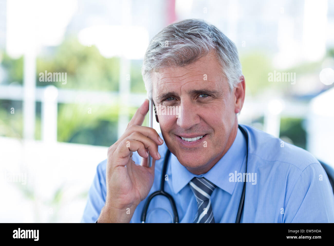 Doctor having phone call Stock Photo - Alamy