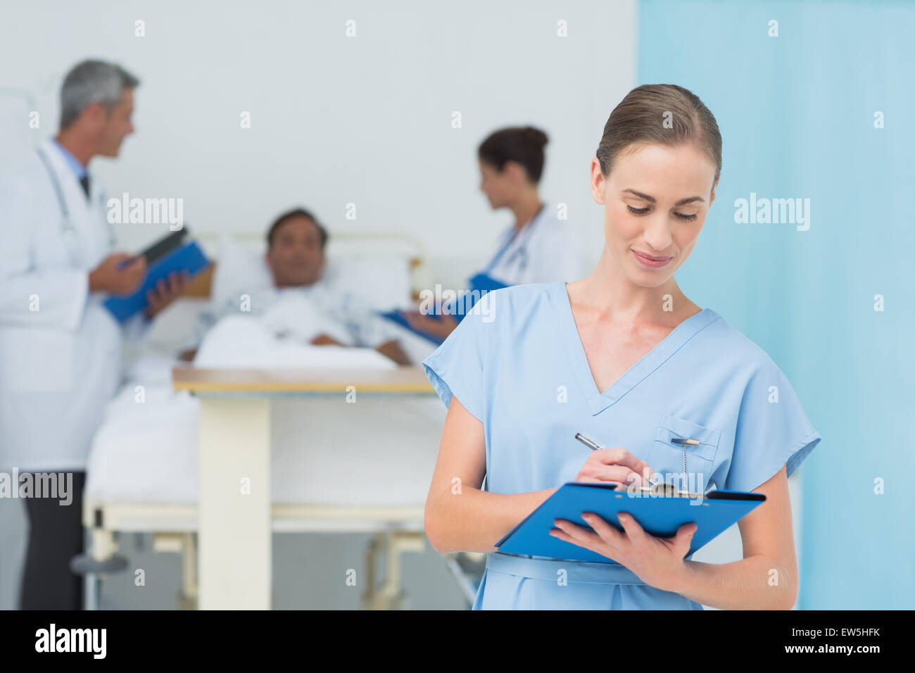 Doctor with colleague and patient behind Stock Photo - Alamy