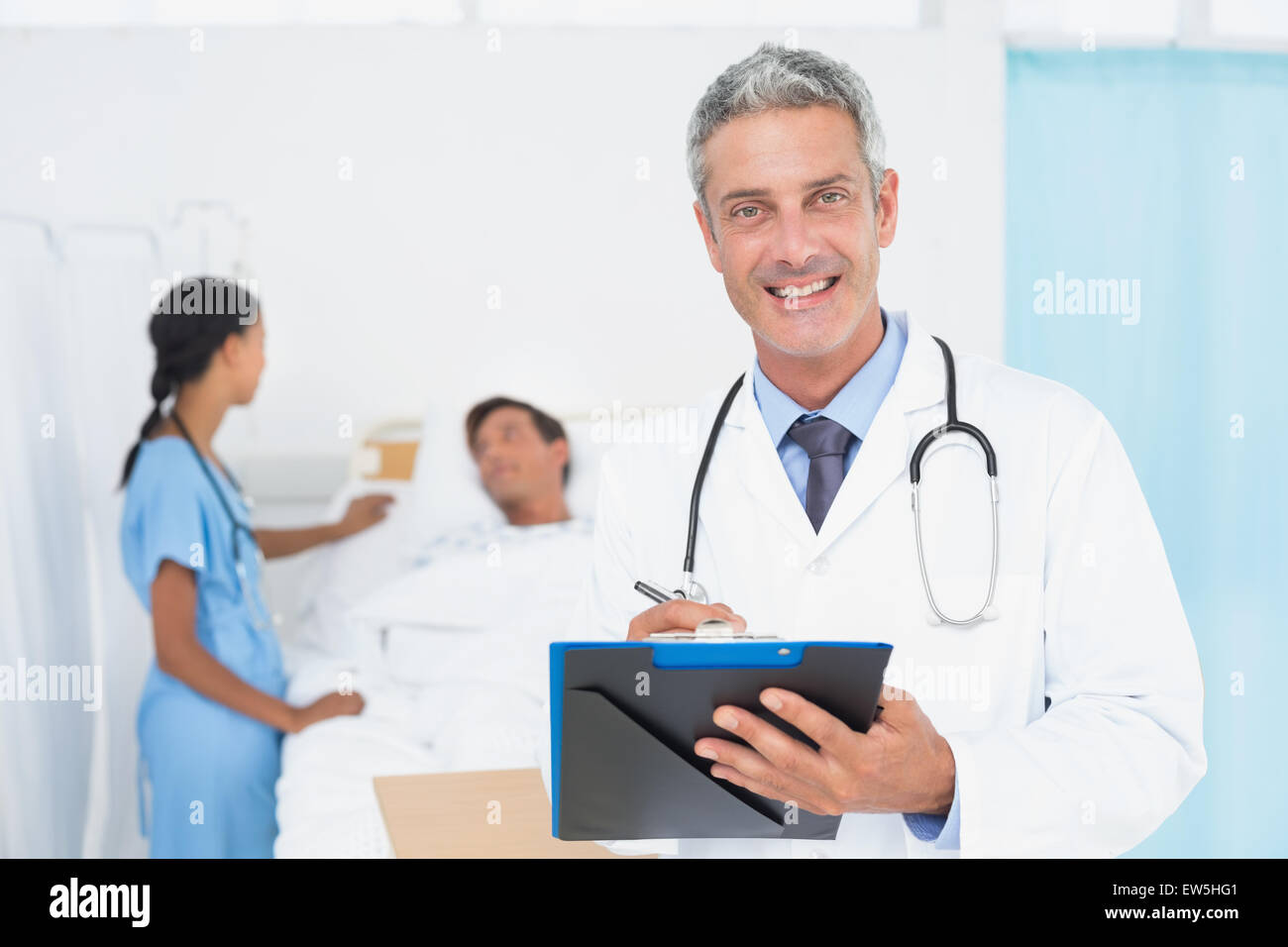 Doctor behind the patient hi-res stock photography and images - Alamy