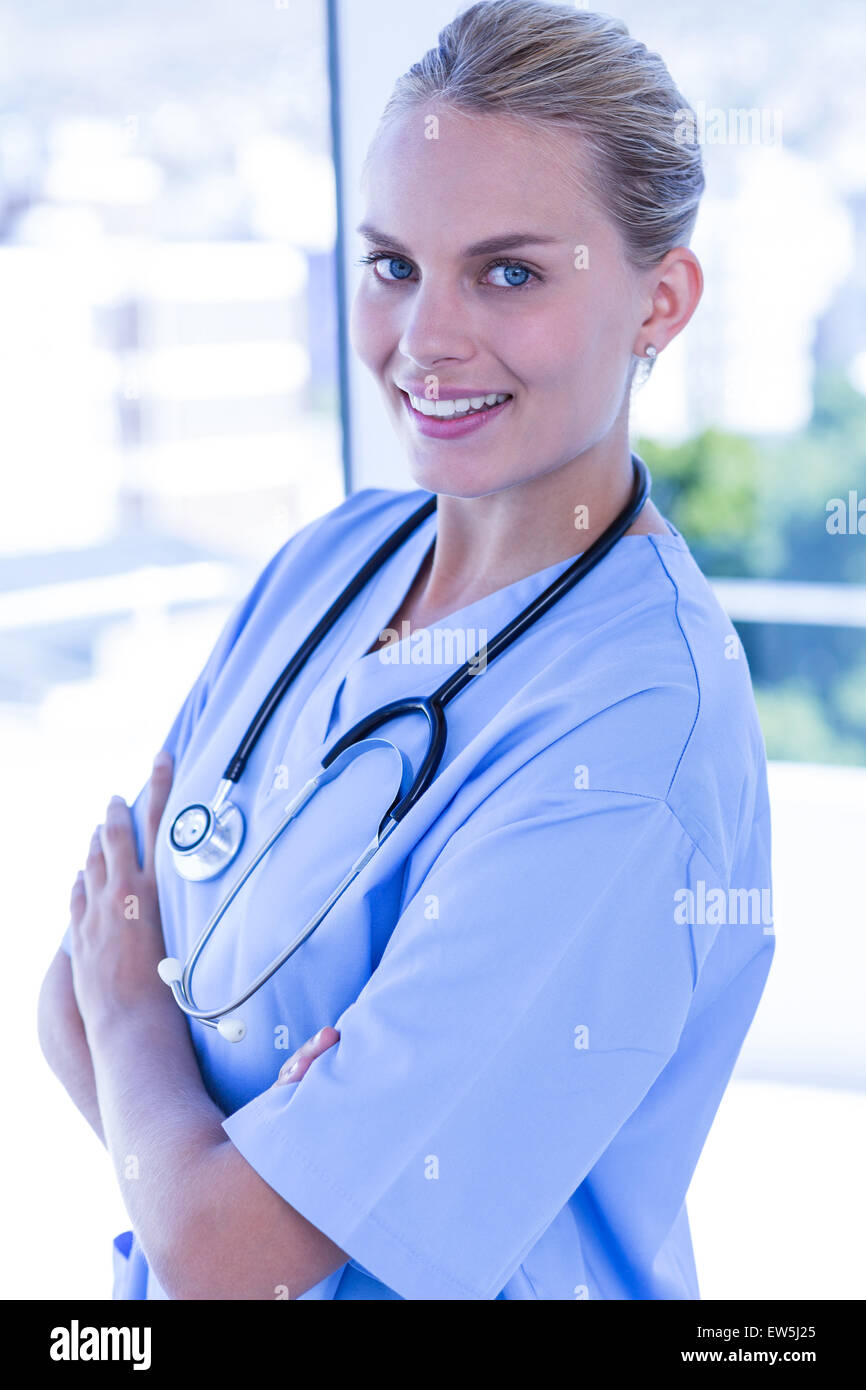 Pretty nurse smiling at the camera Stock Photo - Alamy