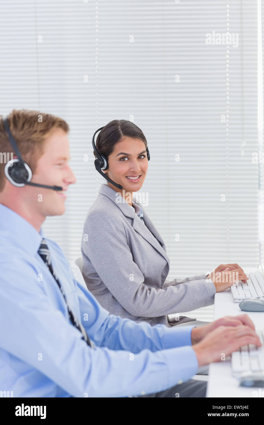 Business team working on computers and wearing headsets Stock Photo - Alamy