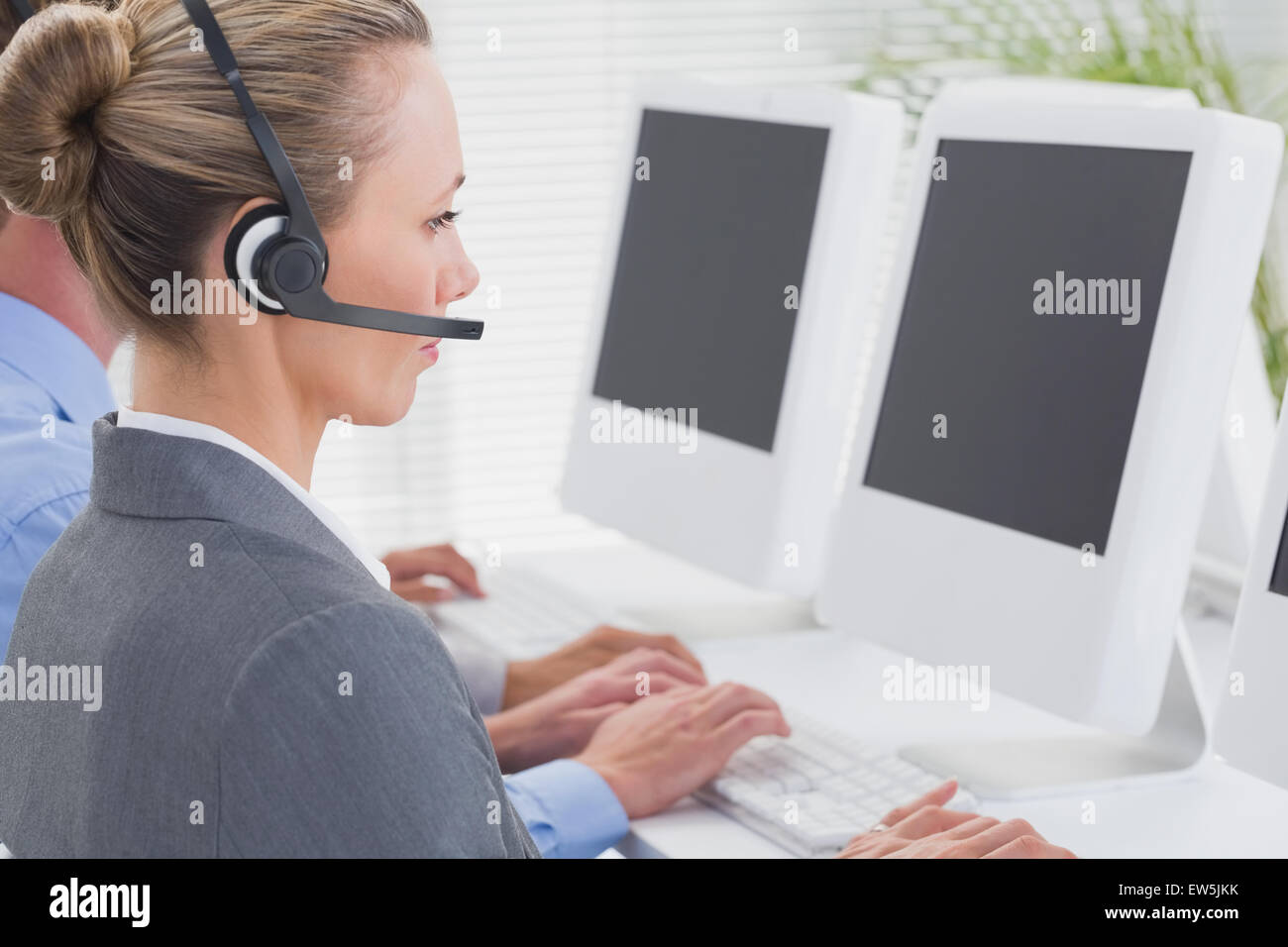 Business team working on computers and wearing headsets Stock Photo - Alamy