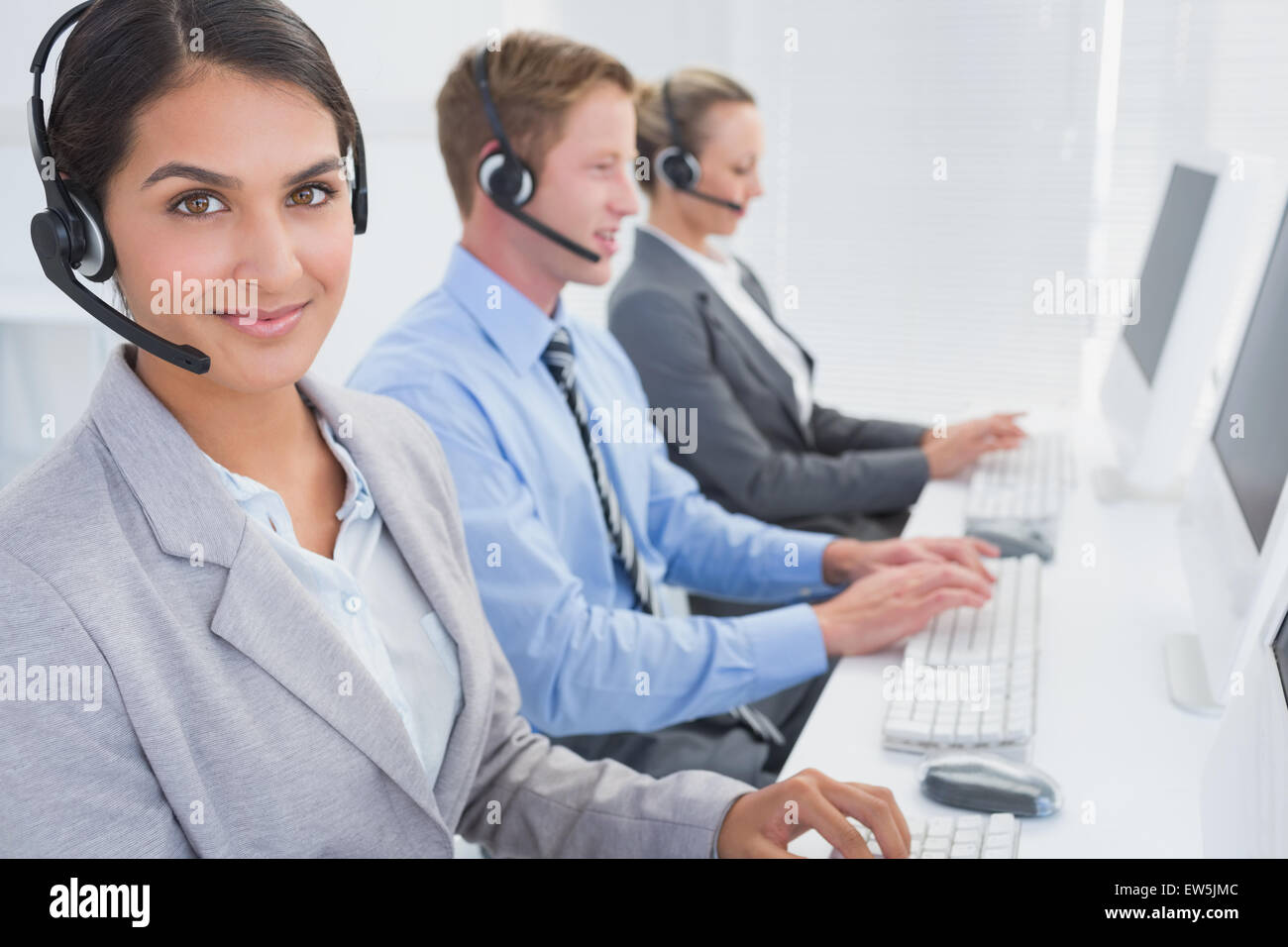 Office team wearing headsets typing hi-res stock photography and images ...