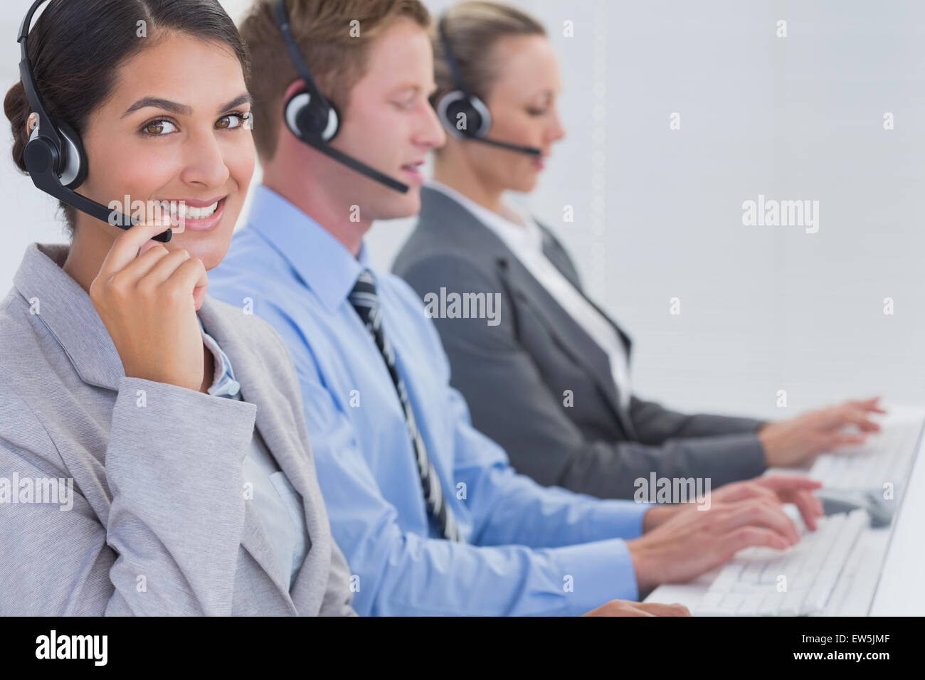 Business team working on computers and wearing headsets Stock Photo - Alamy