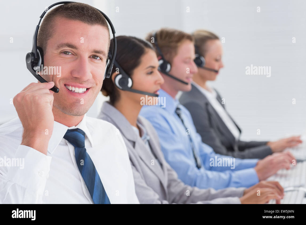 Business team working on computers and wearing headsets Stock Photo - Alamy