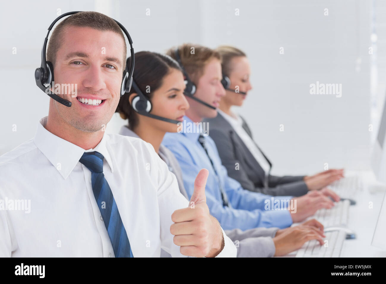 Business team working on computers and wearing headsets Stock Photo - Alamy