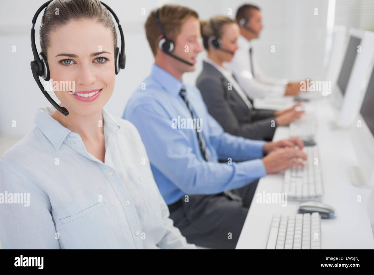 Business team working on computers and wearing headsets Stock Photo - Alamy