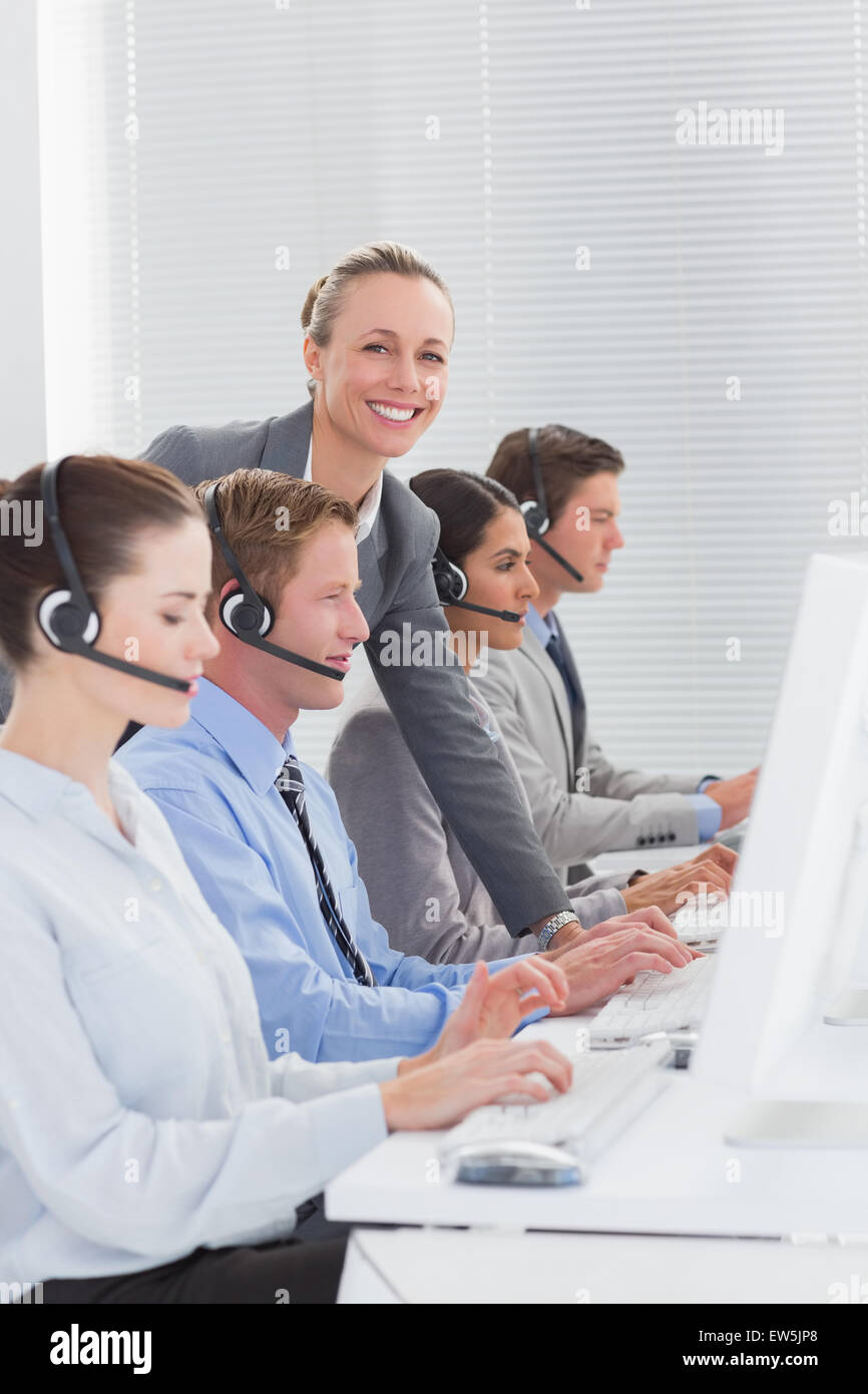Manager checking the work of the staff Stock Photo - Alamy