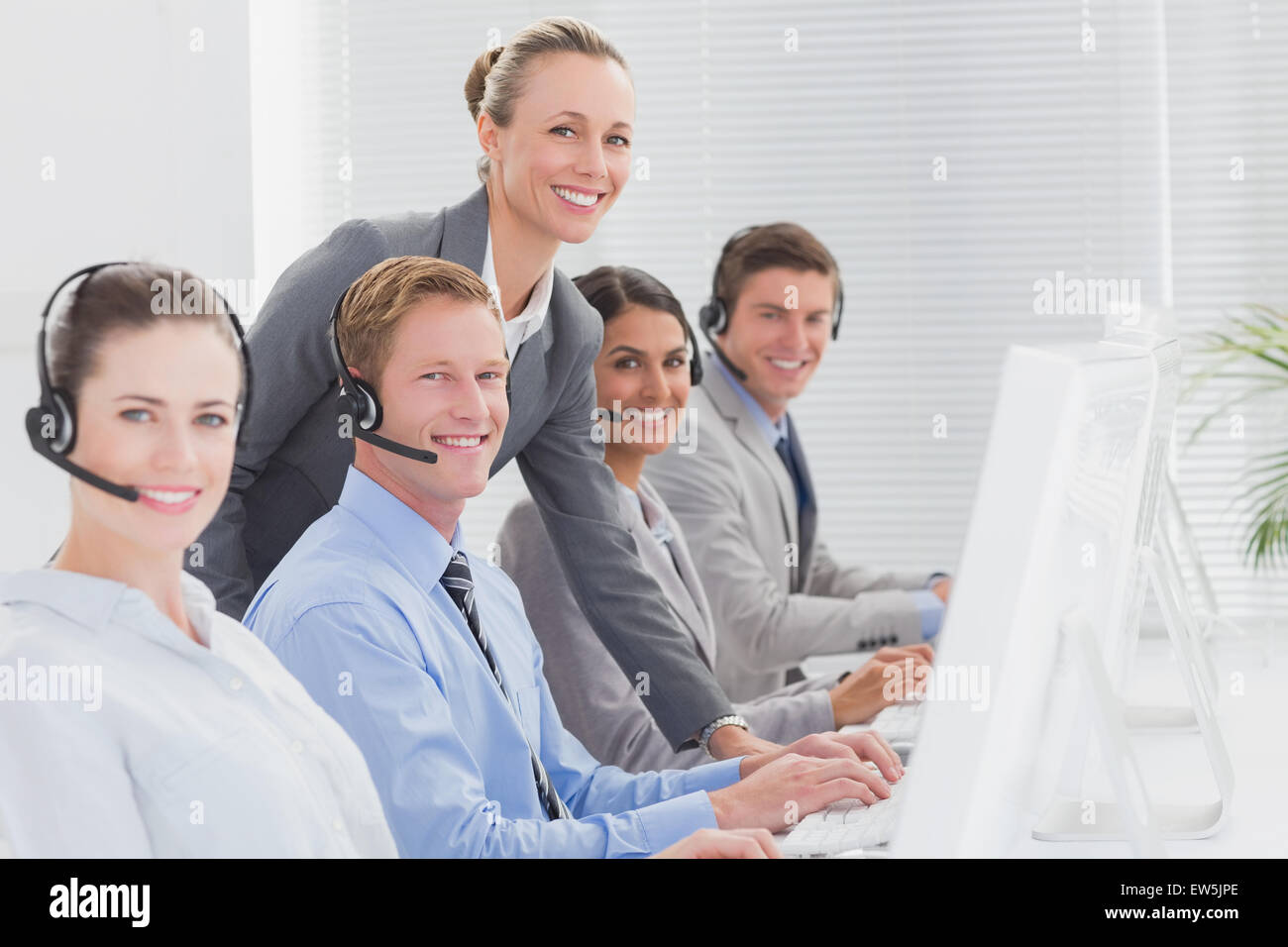 Manager checking the work of the staff Stock Photo - Alamy