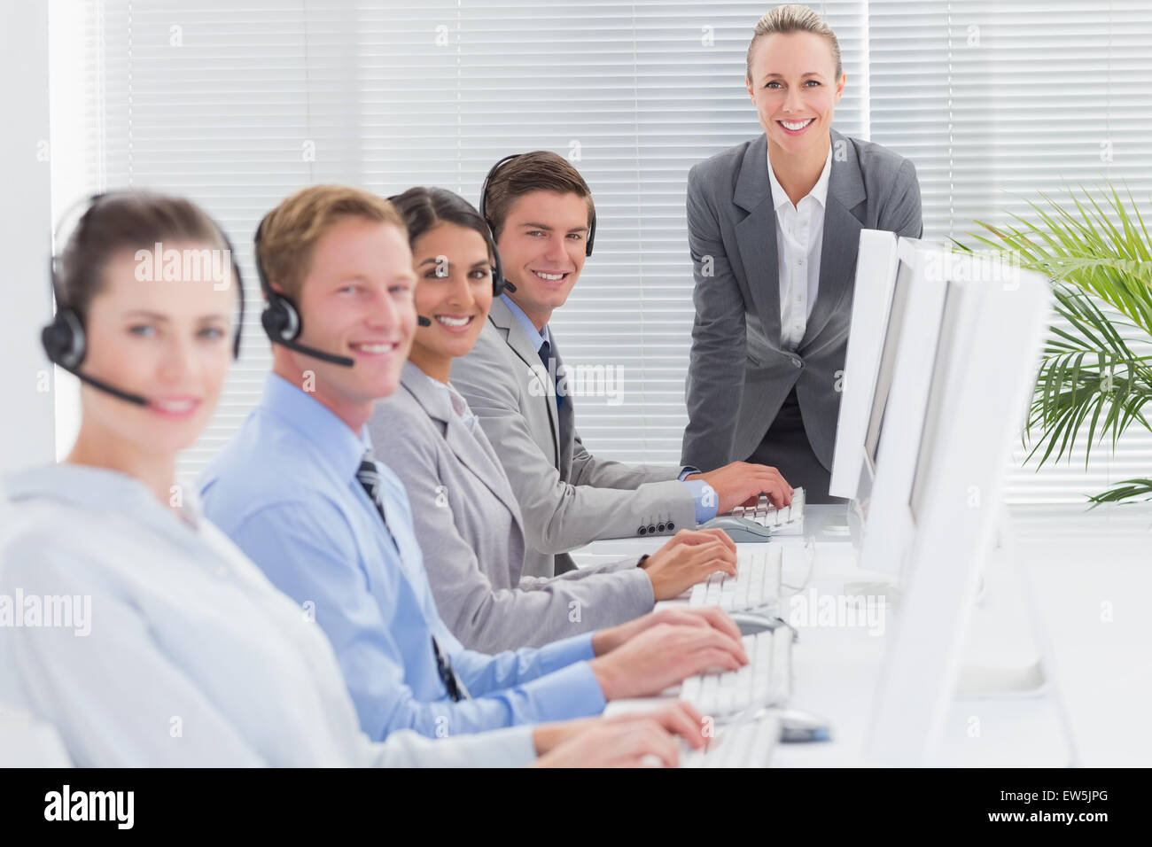 Manager checking the work of the staff Stock Photo - Alamy