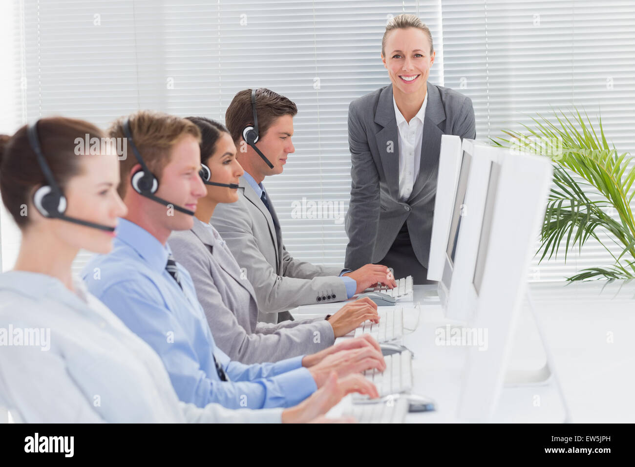 Manager checking the work of the staff Stock Photo - Alamy