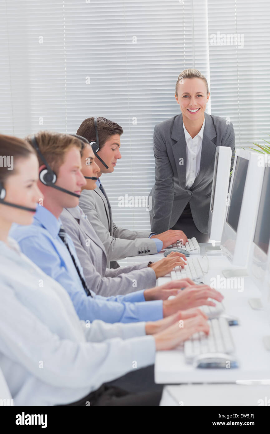 Manager checking the work of the staff Stock Photo - Alamy