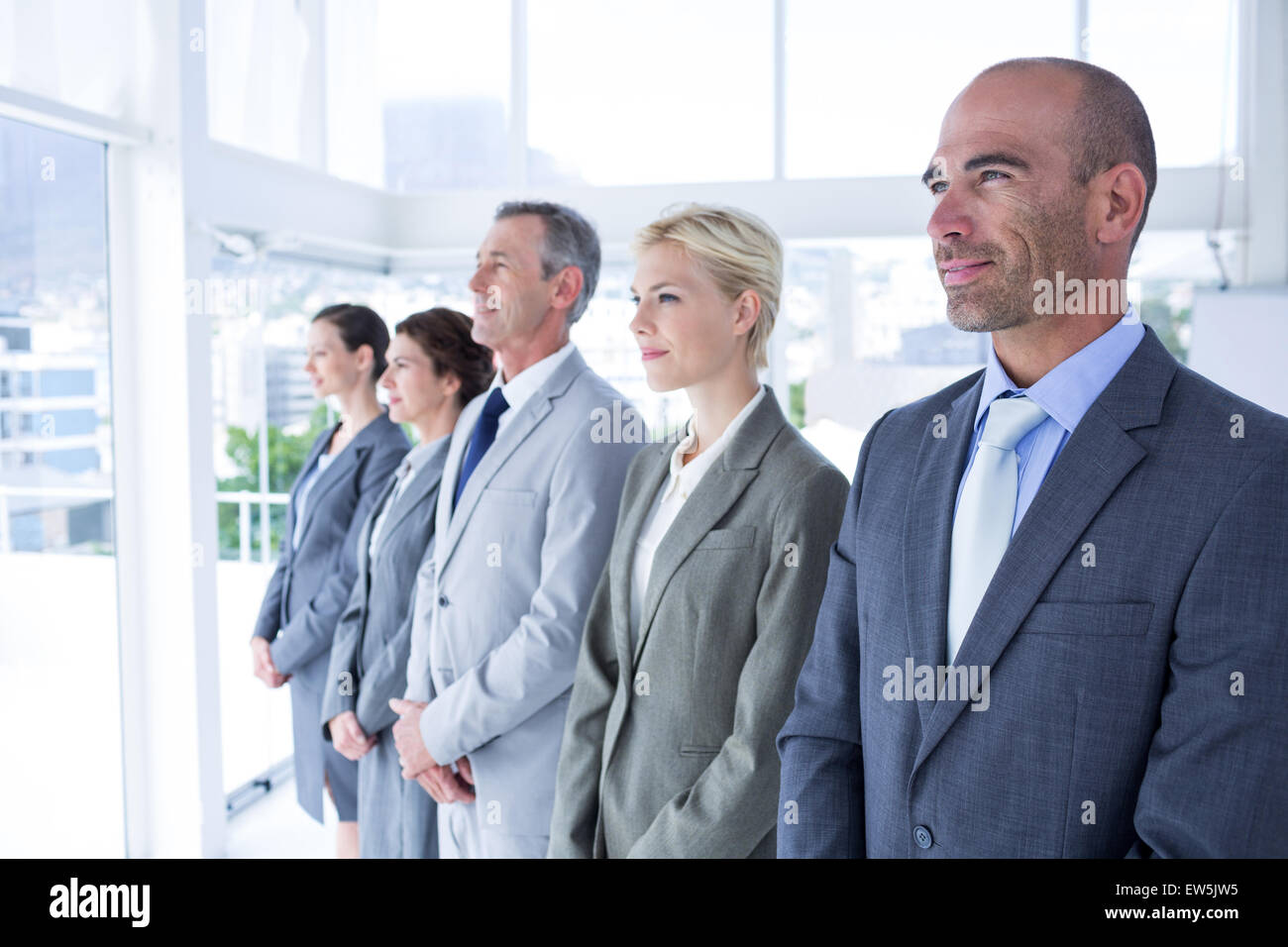 Business people standing in a row Stock Photo - Alamy
