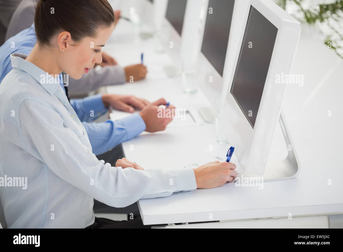 Business team writing brainstorming ideas in their notepad Stock Photo ...