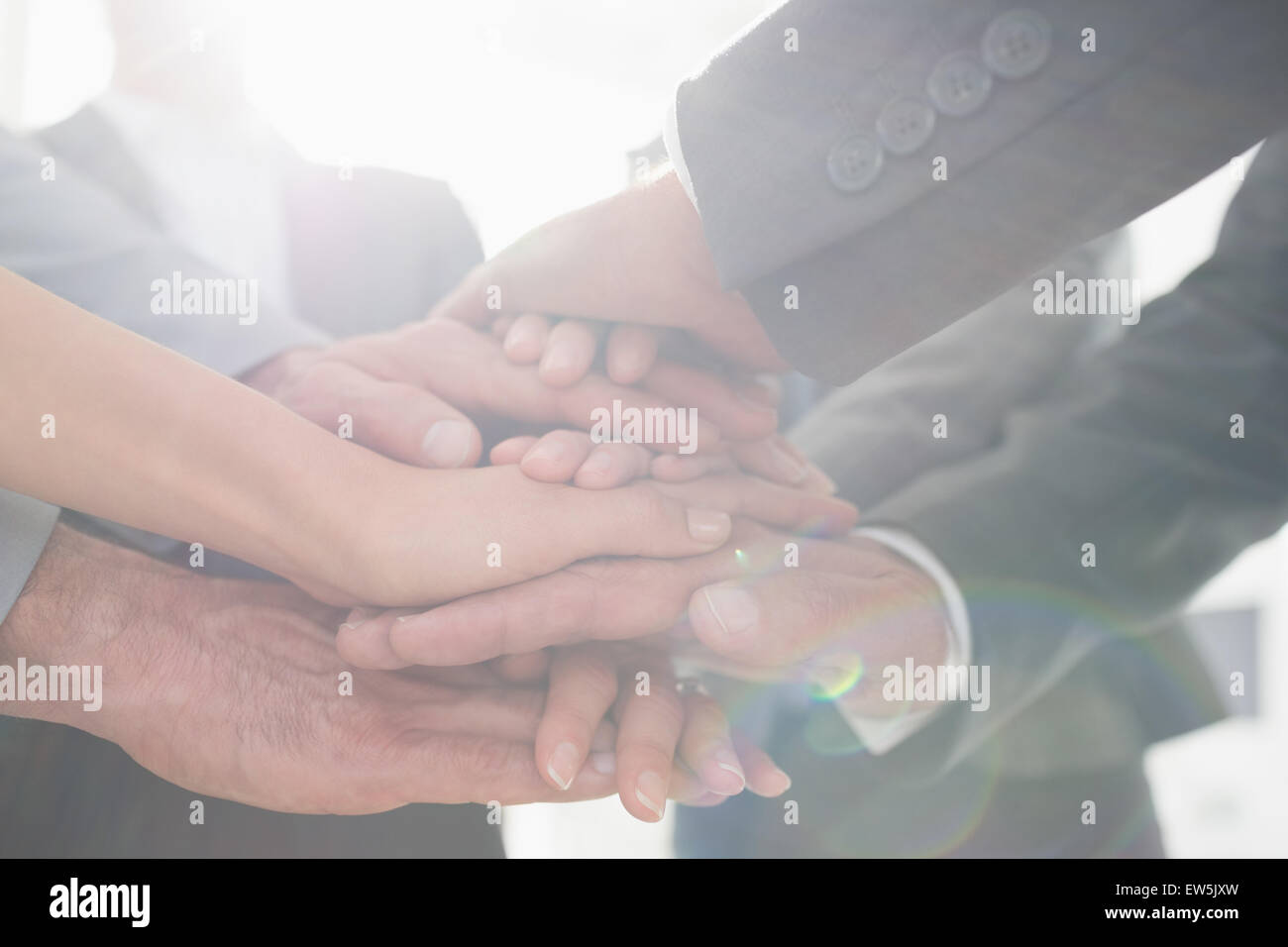 Business team standing hands together Stock Photo - Alamy