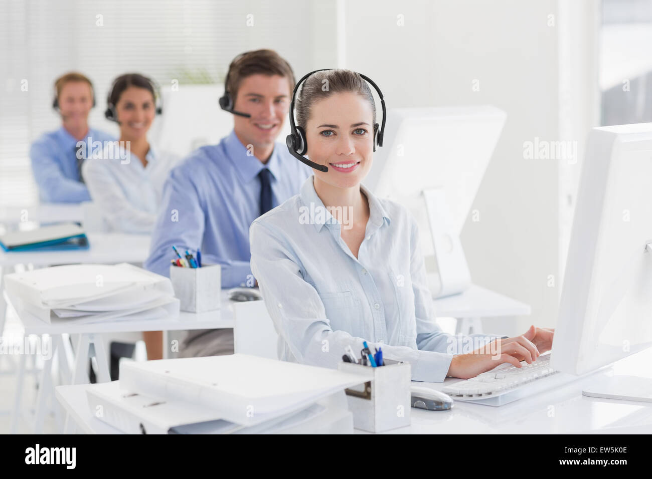 Business team working on computers and wearing headsets Stock Photo - Alamy