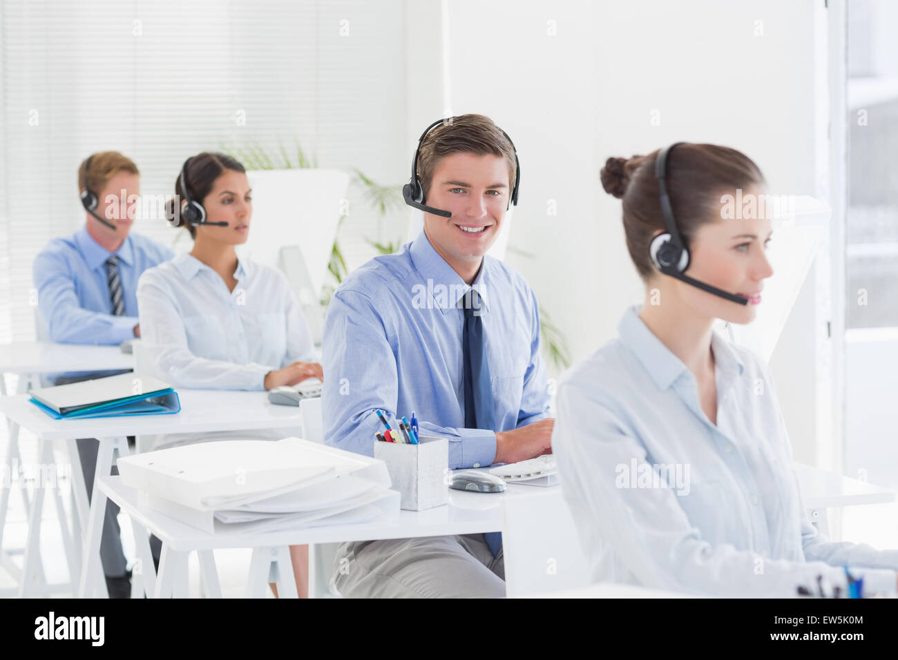 Office team wearing headsets typing hi-res stock photography and images ...