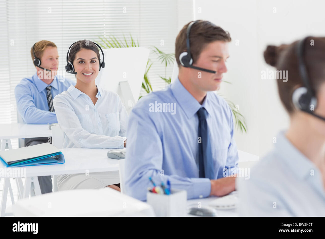 Business team working on computers and wearing headsets Stock Photo - Alamy