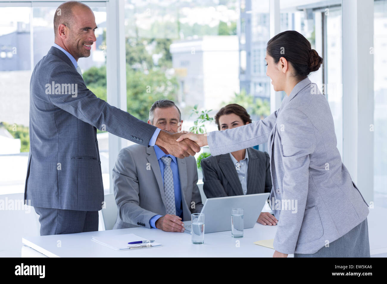 Interview panel shaking hands with applicant Stock Photo - Alamy