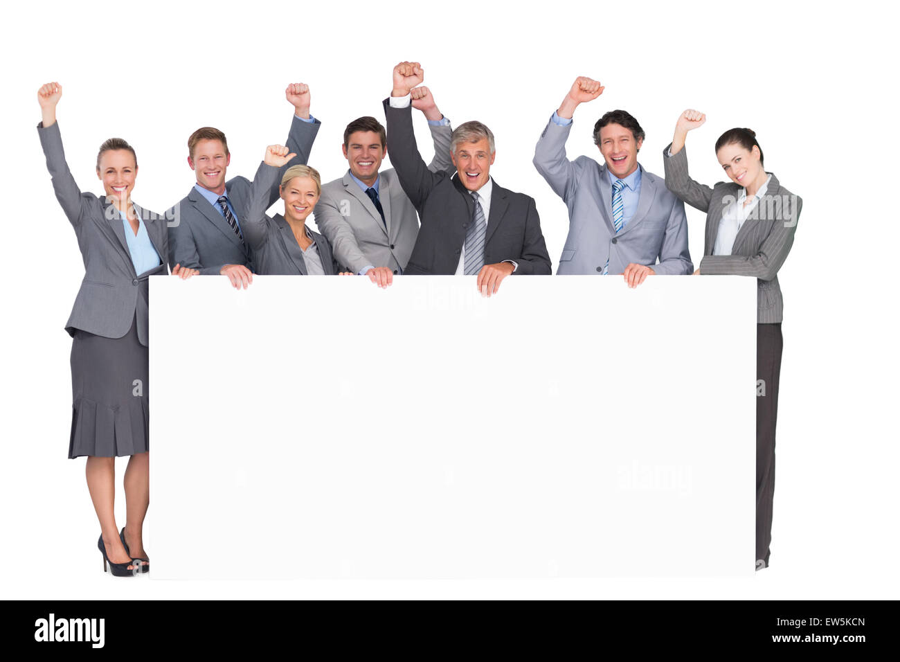 Excited business team holding poster Stock Photo - Alamy