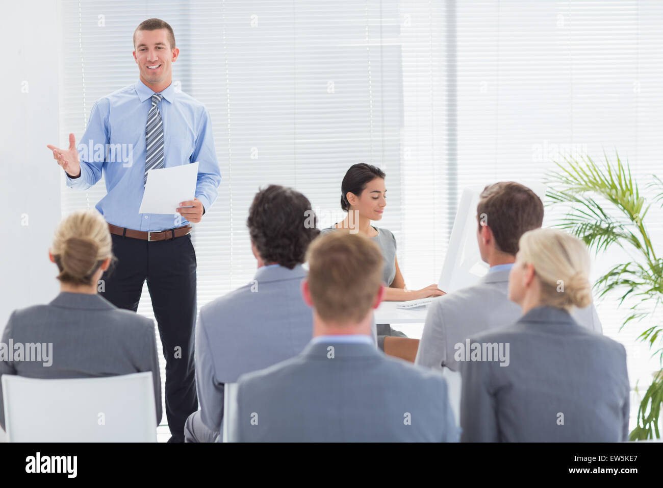 Smiling businessman talking during conference Stock Photo - Alamy