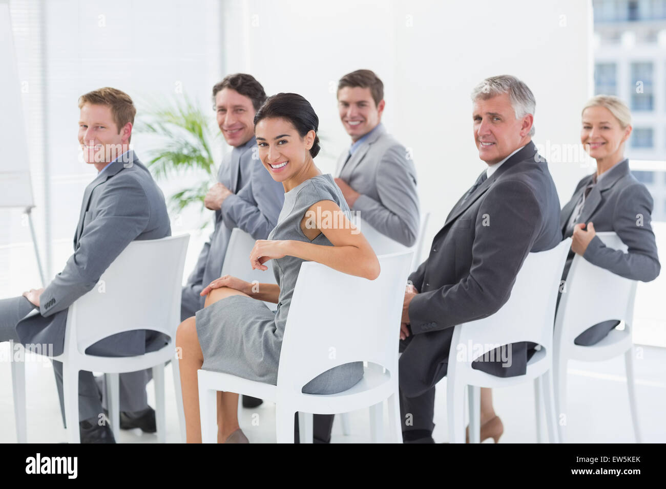 Smiling business team looking at camera during conference Stock Photo ...
