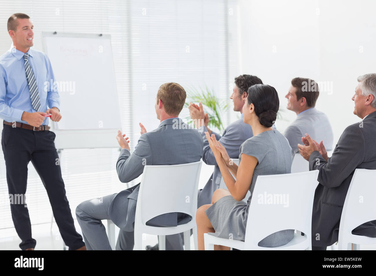 Smiling business team applauding during conference Stock Photo - Alamy