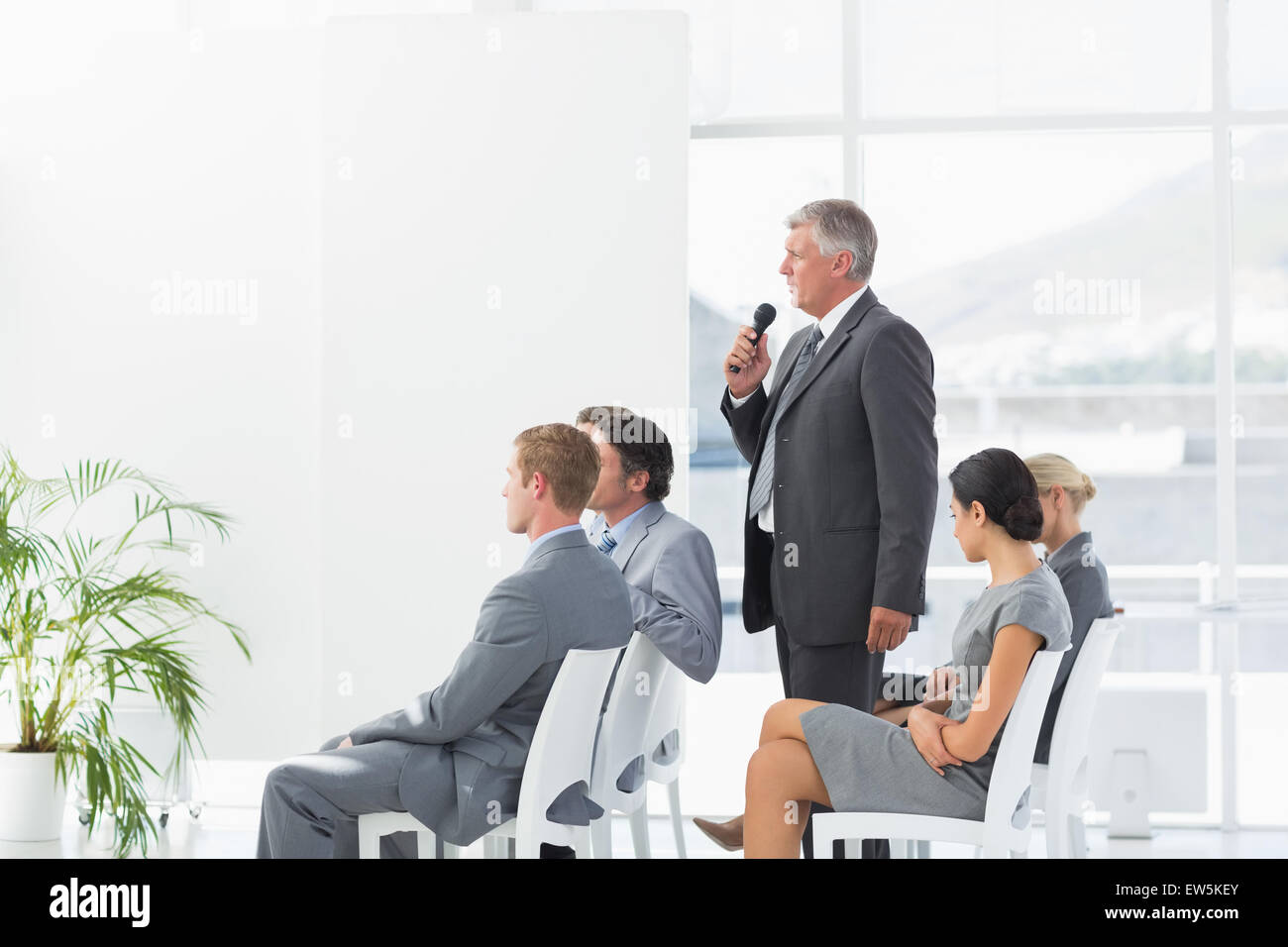 Businessman talking in microphone during conference Stock Photo - Alamy