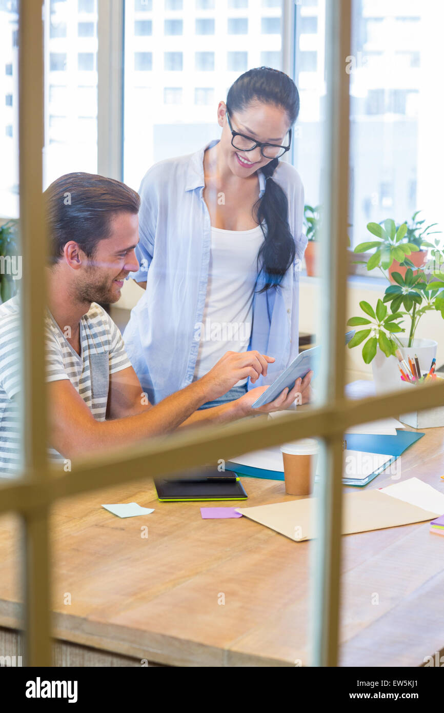 Smiling partners working together on tablet Stock Photo - Alamy