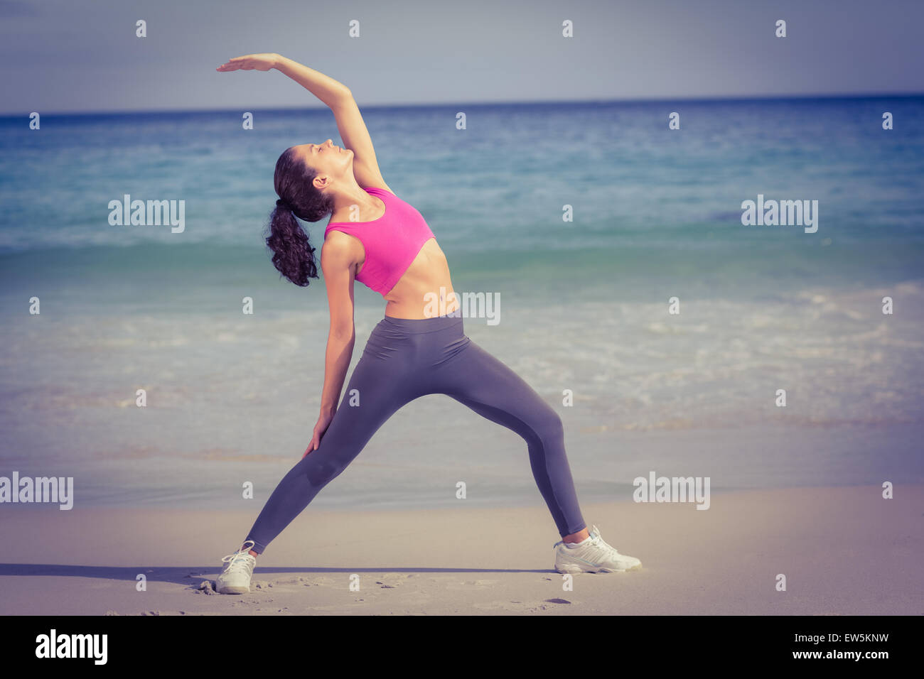 Fit woman making stretching on the beach Stock Photo - Alamy