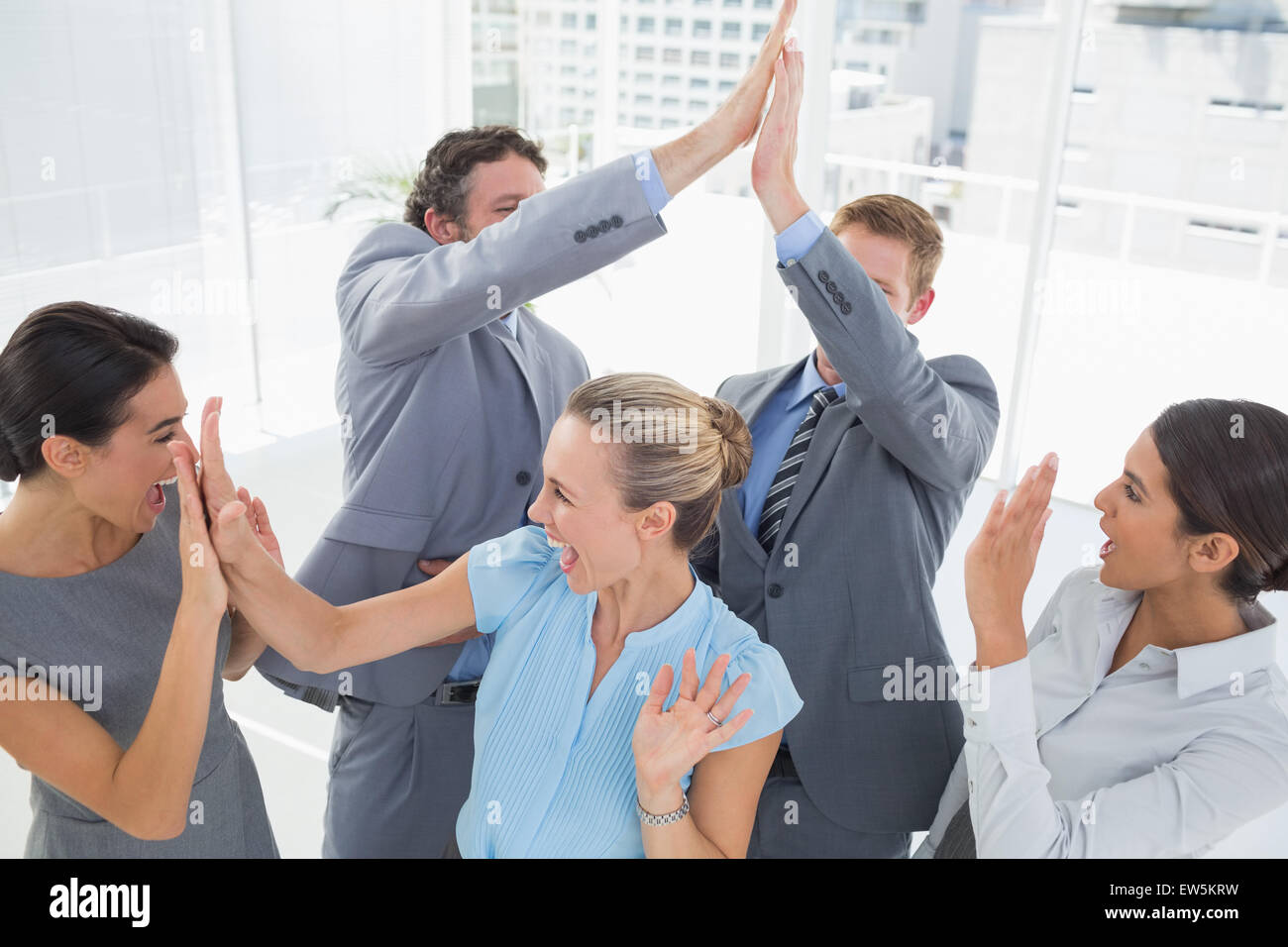 Excited business team cheering Stock Photo - Alamy