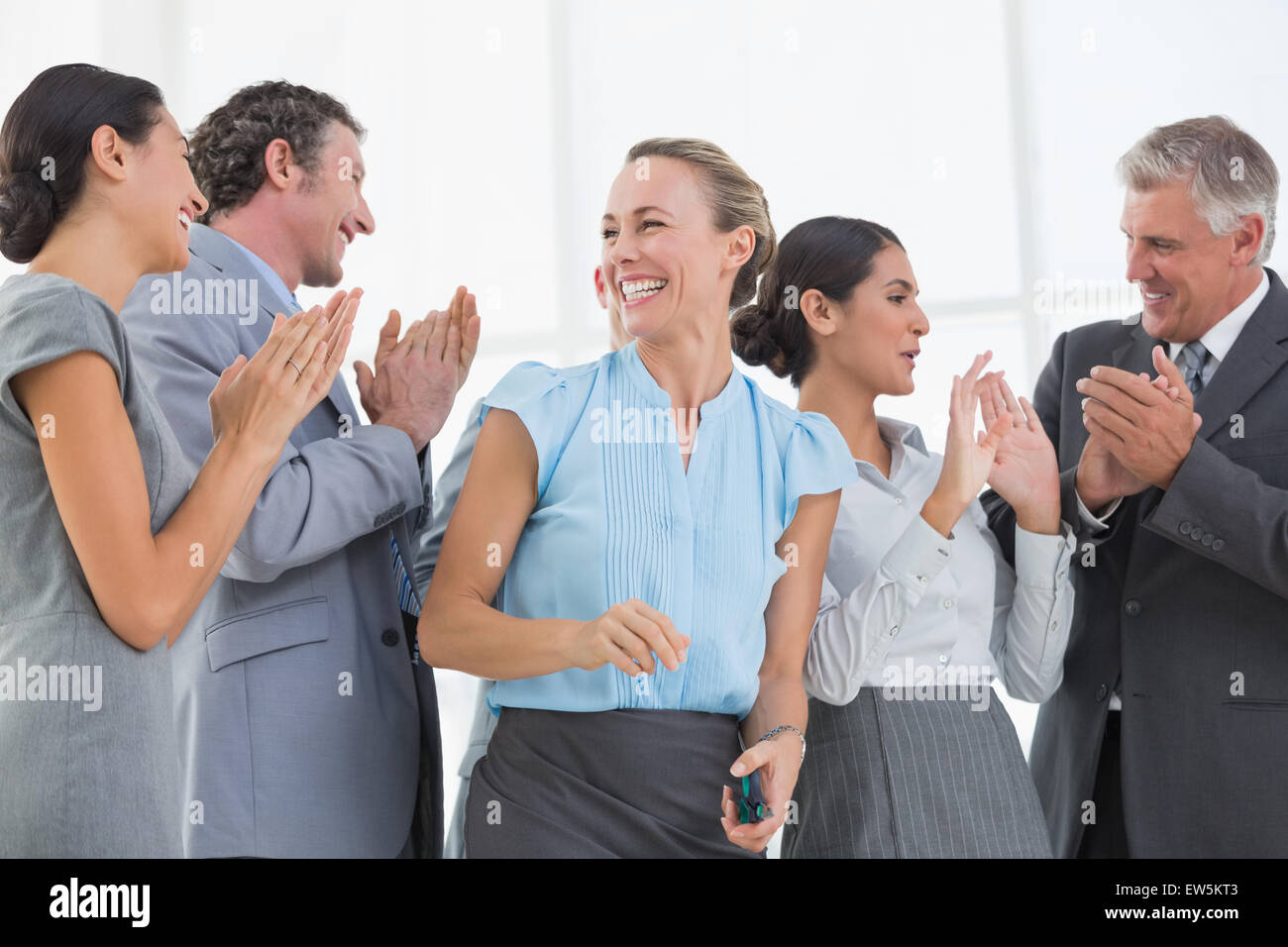 Happy business team smiling at each other Stock Photo - Alamy