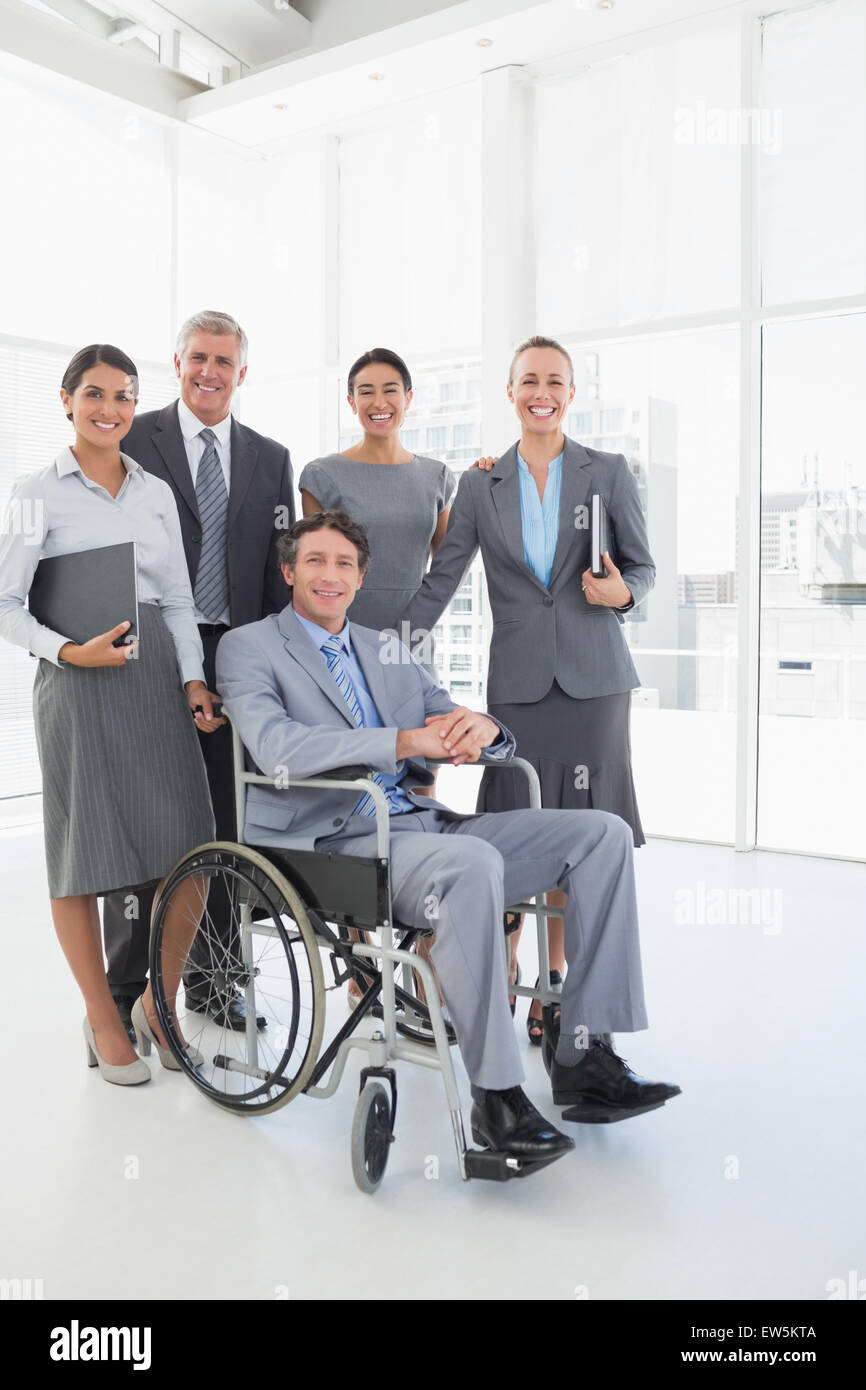 Disabled businessman with his colleagues smiling at camera Stock Photo ...
