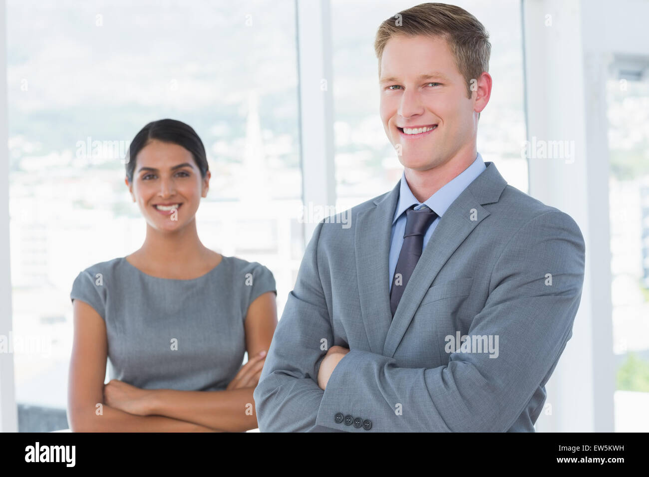 Smiling business colleagues smiling at camera Stock Photo - Alamy