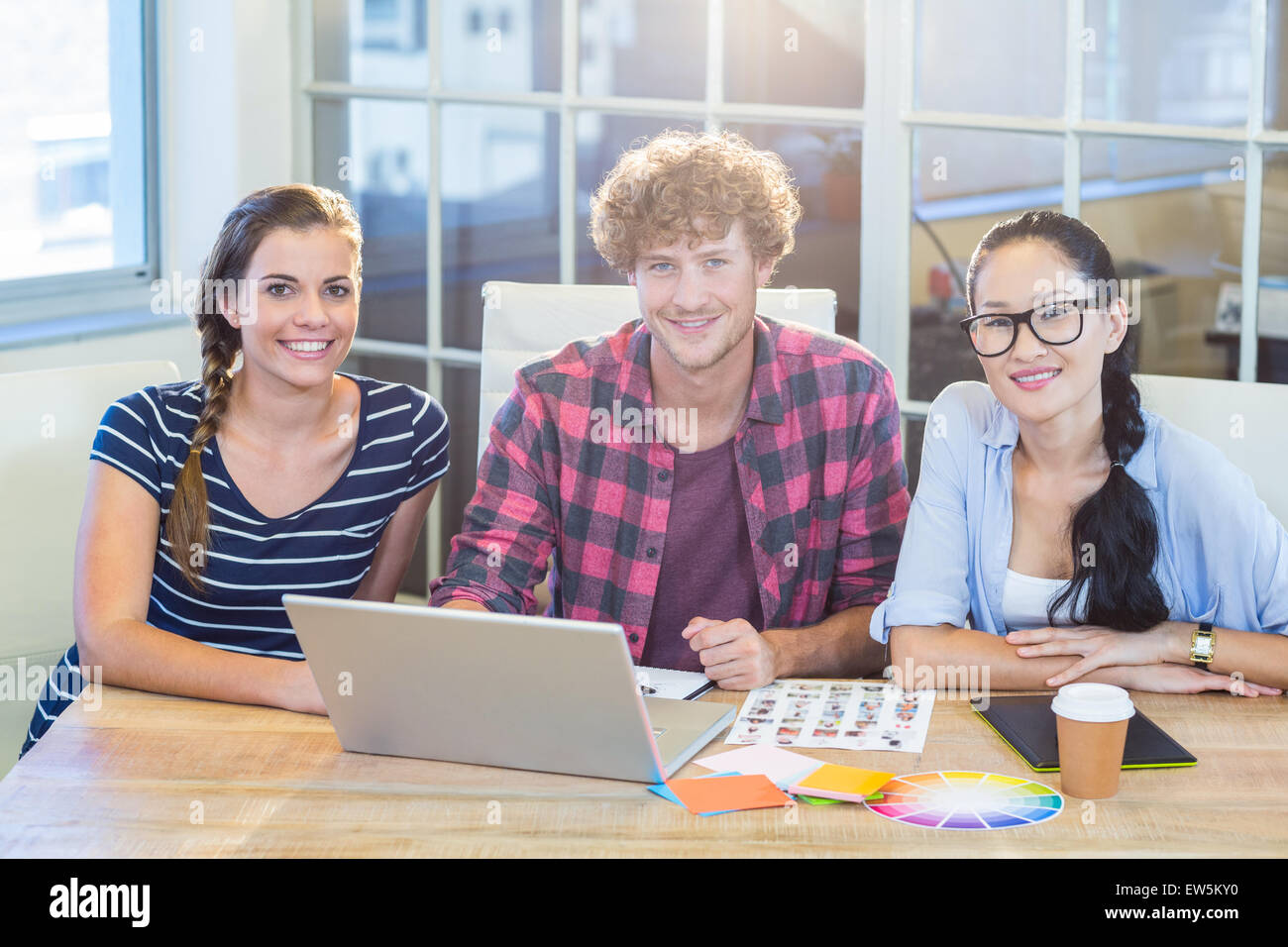 Smiling partners working together with photographs Stock Photo - Alamy