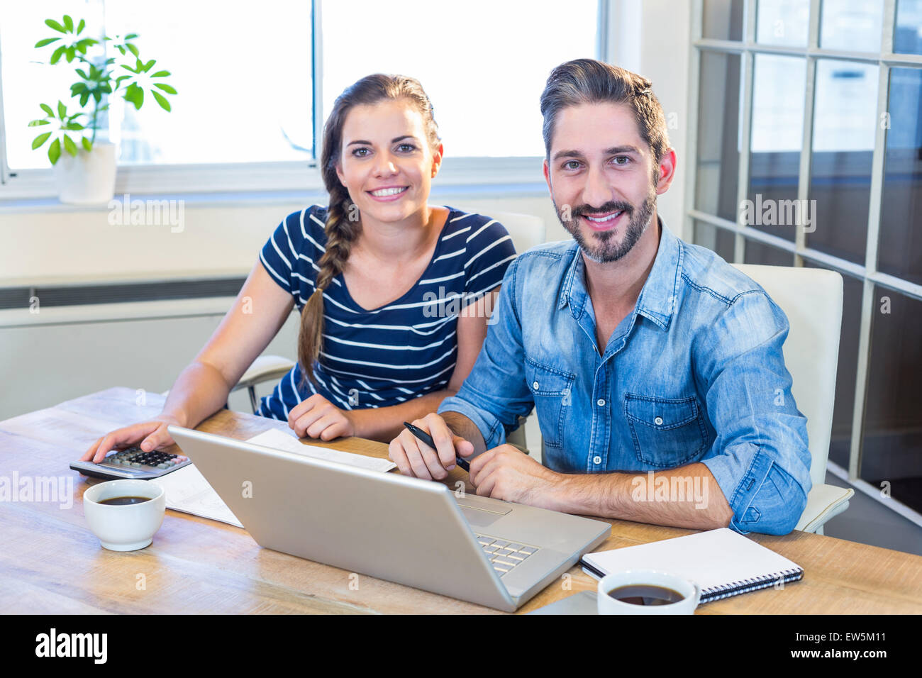 Partners smiling at camera Stock Photo - Alamy