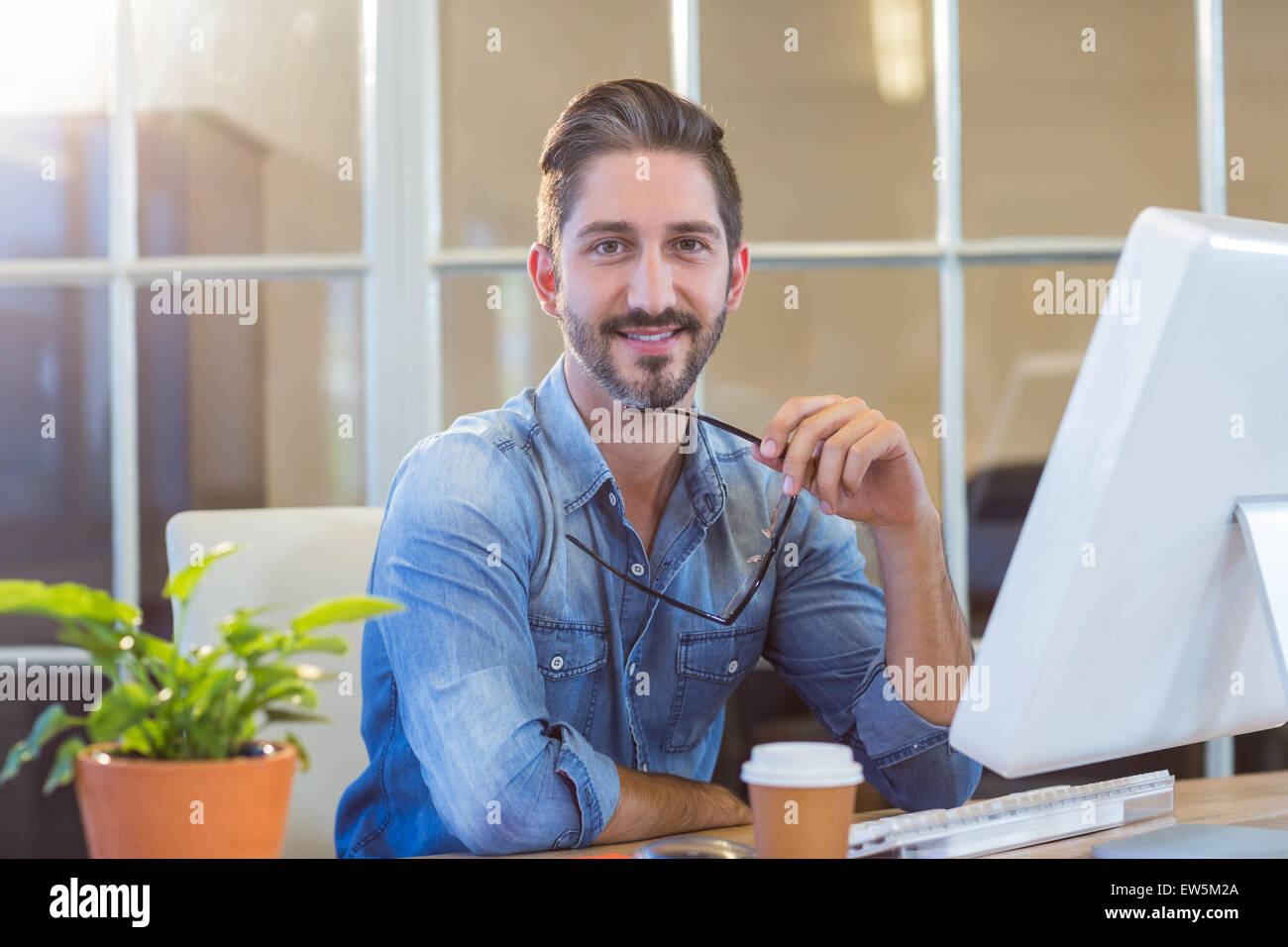 Happy businessman holding plant hi-res stock photography and images - Alamy