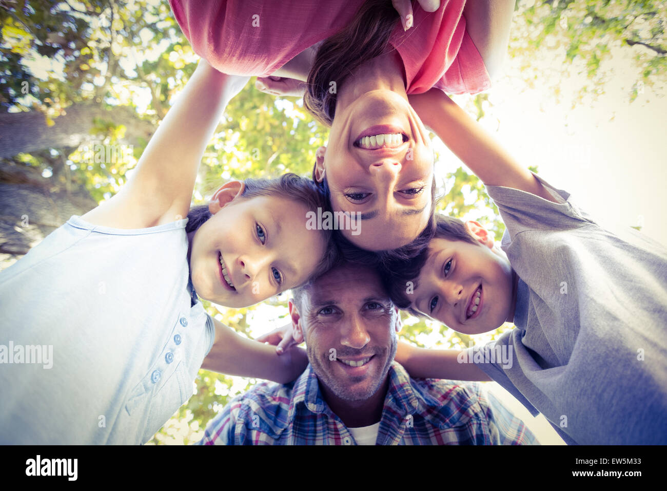Happy family in the park huddling in circle Stock Photo - Alamy
