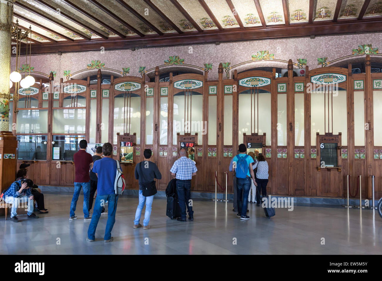 Passengers buying train tickets in the North Station of Valencia, Spain ...