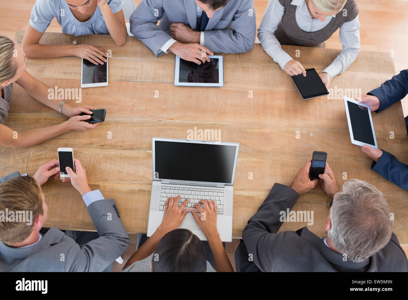 Business team working on their multimedia devices Stock Photo - Alamy