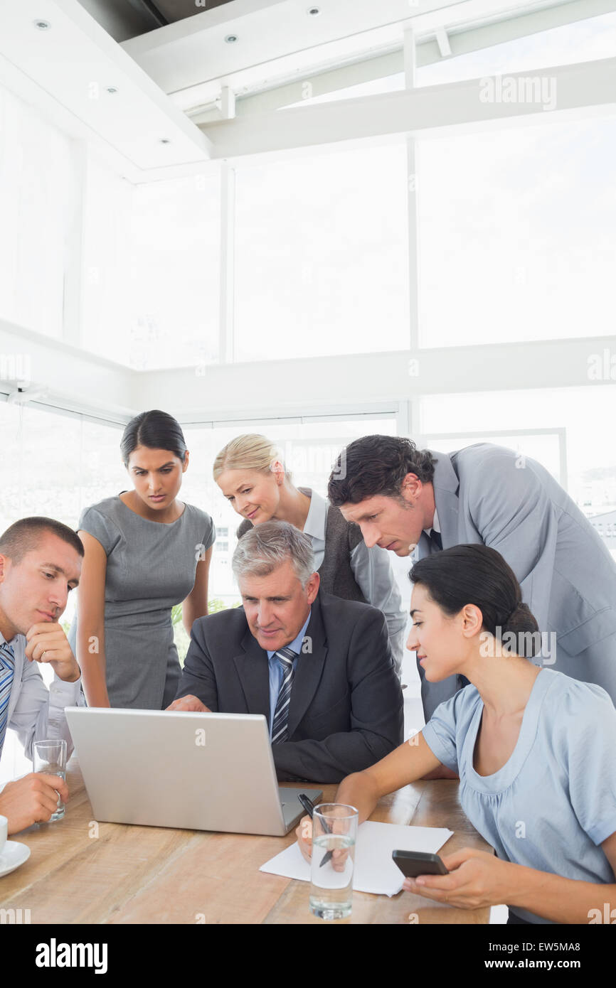 Concentrated business team working on laptop Stock Photo - Alamy