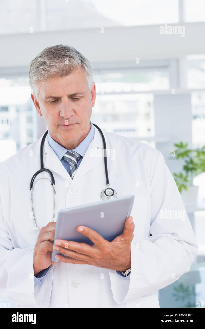 Smiling doctor holding tablet Stock Photo - Alamy