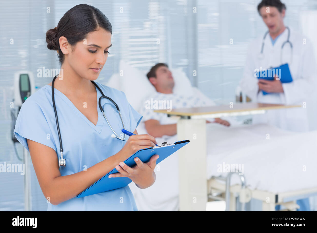 Doctors taking care of patient Stock Photo - Alamy