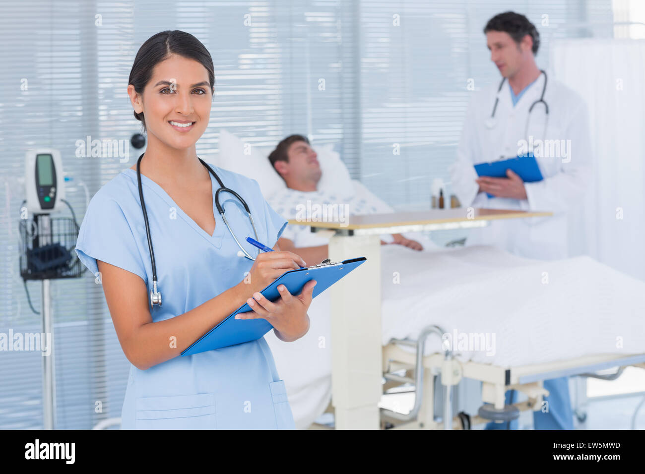 Doctors taking care of patient Stock Photo - Alamy